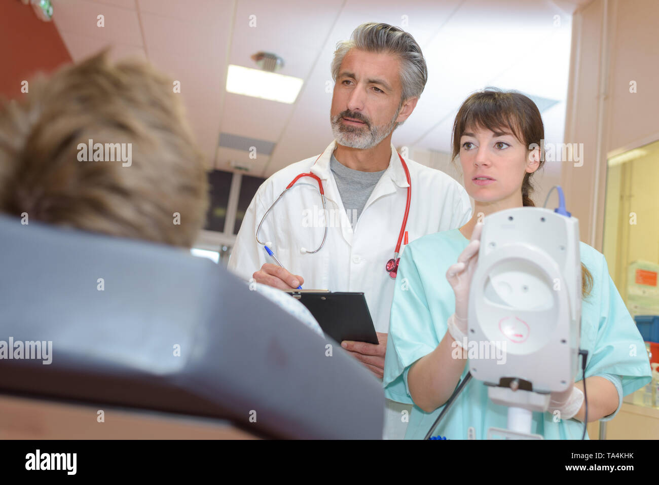 medical staffs conducting an interview to the patient Stock Photo - Alamy