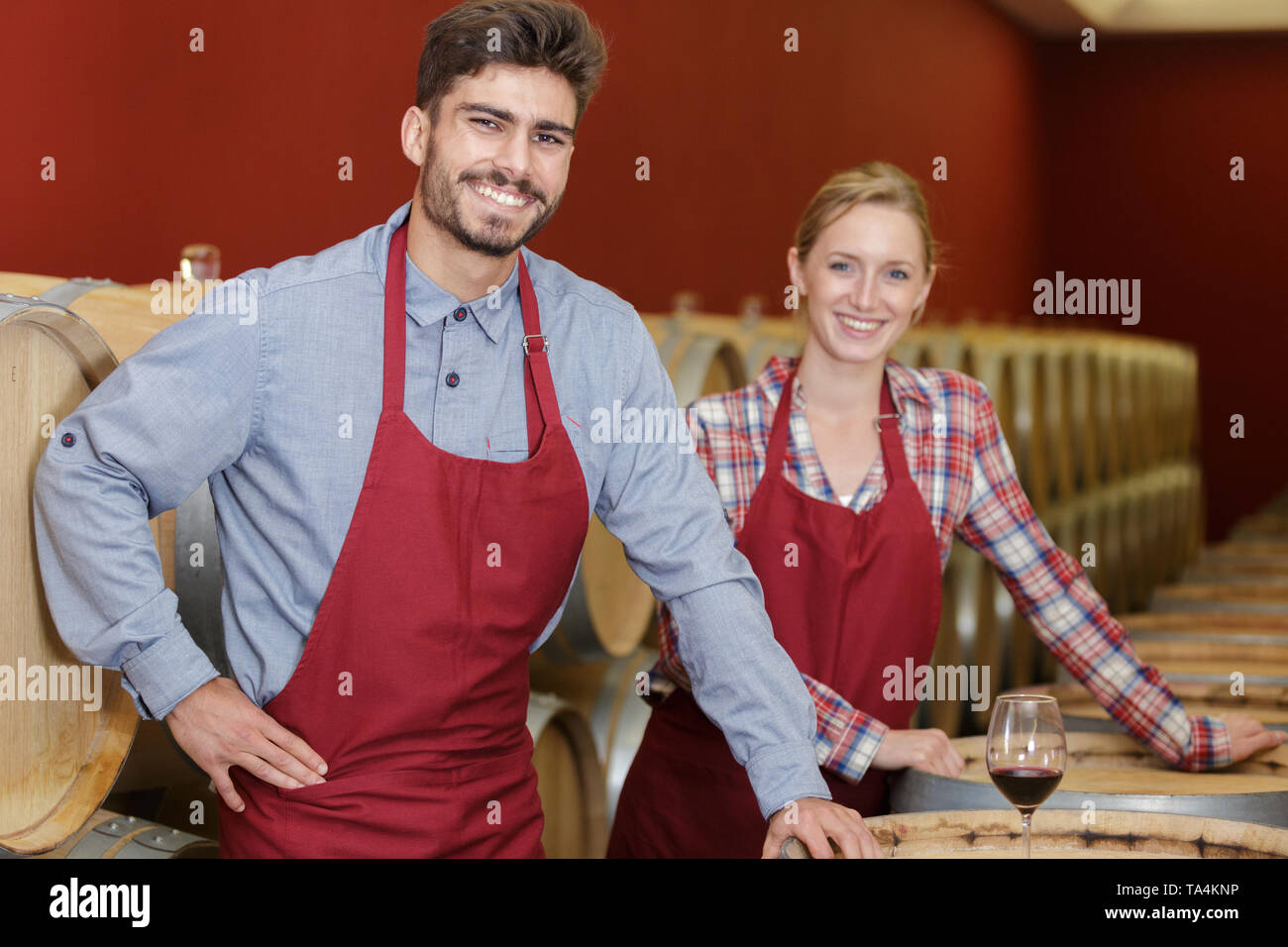 portrait of man and woman winery workers in cellar Stock Photo - Alamy