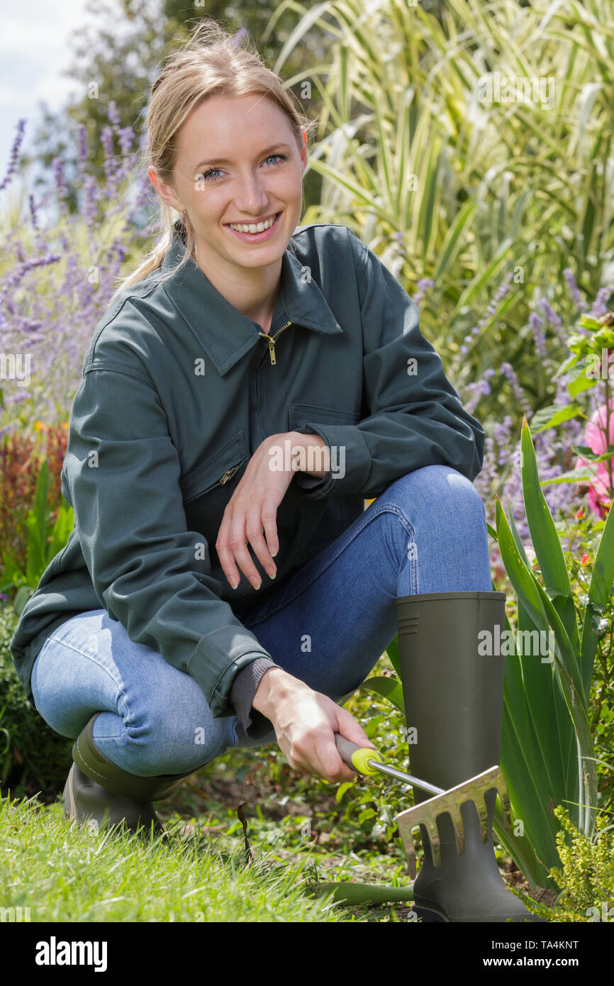 young female gardener using a rake Stock Photo - Alamy