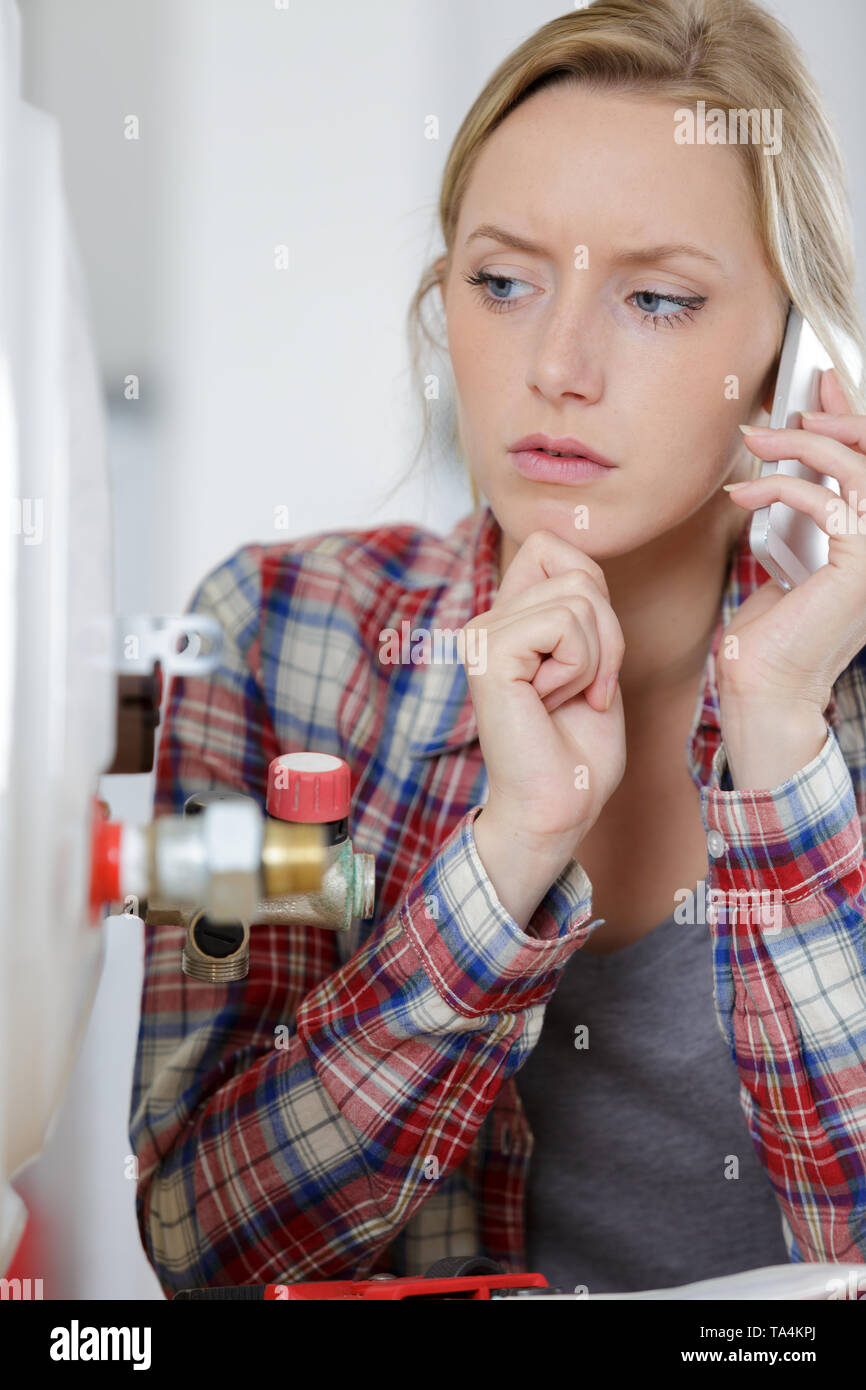 Woman calling plumber hi-res stock photography and images - Alamy