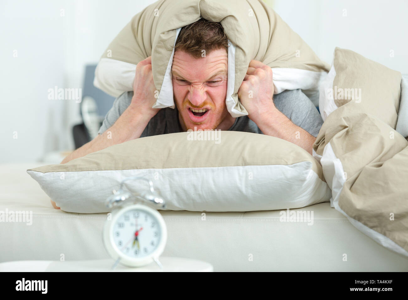 Man covering up body bed hi-res stock photography and images - Alamy