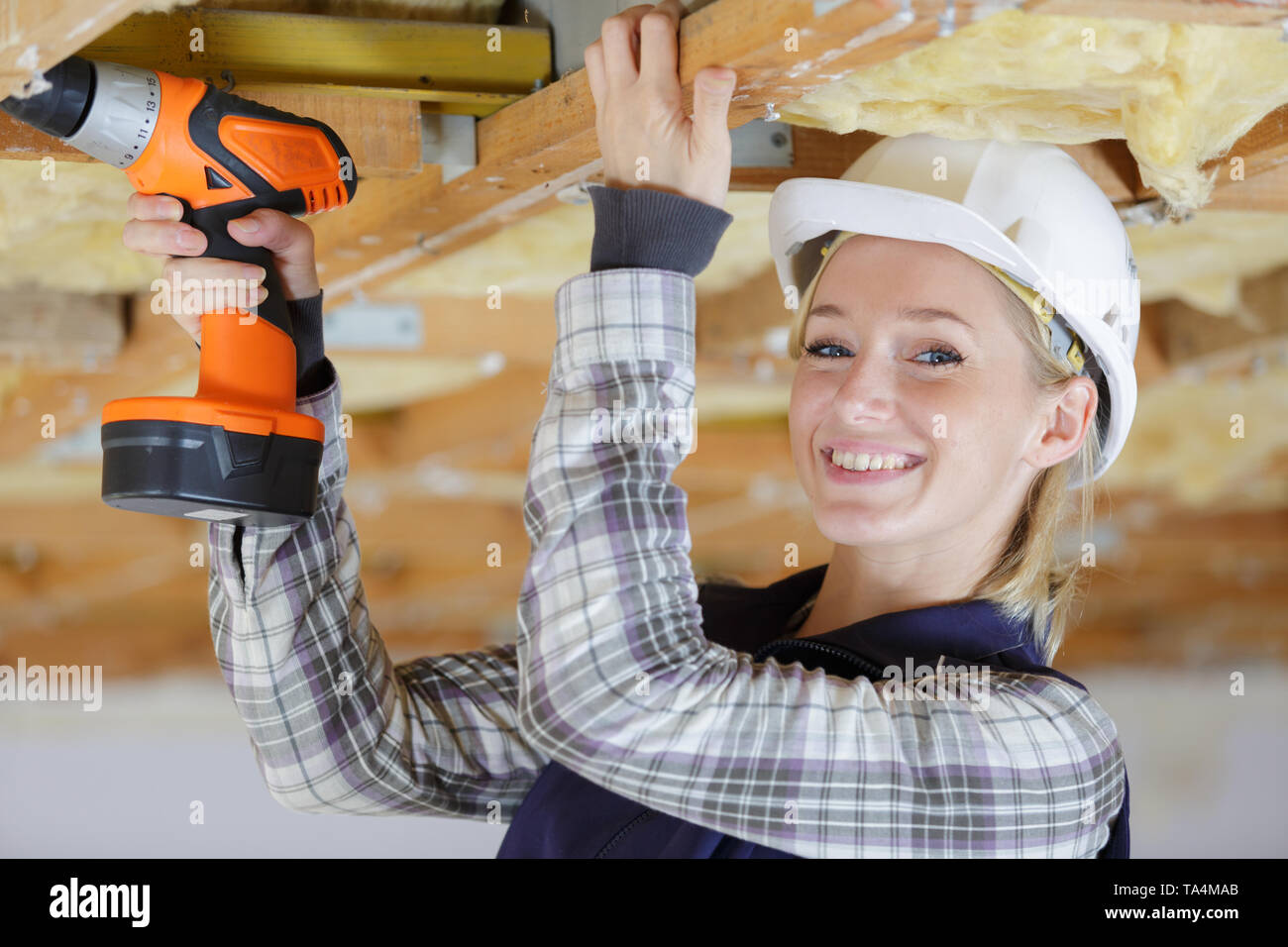 happy female drilling indoors Stock Photo - Alamy