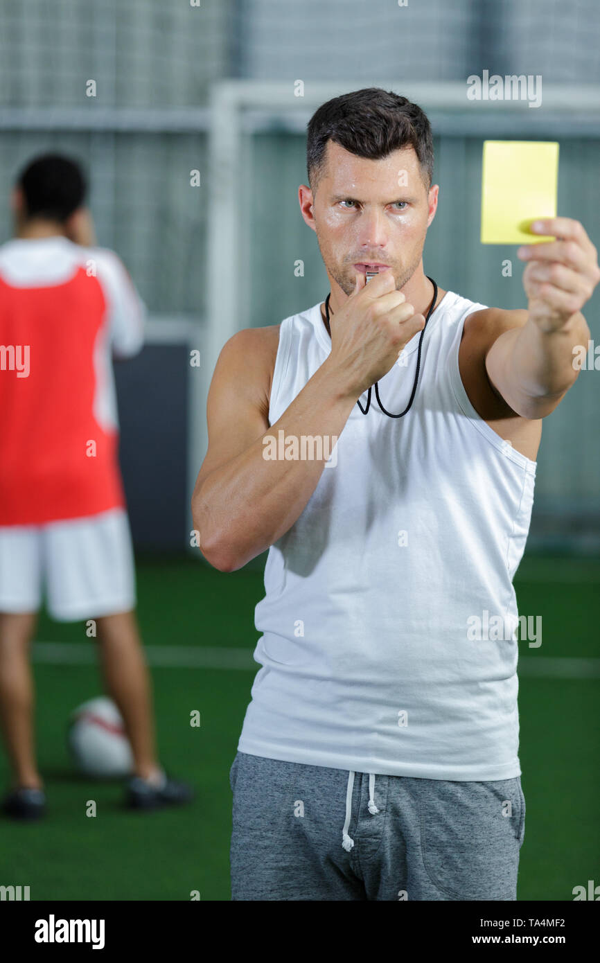 soccer referee showing yellow card to players during game Stock Photo ...