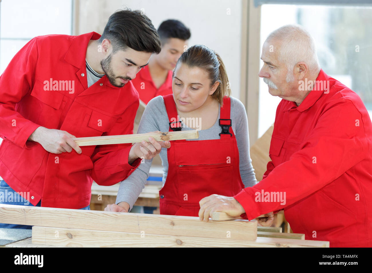 students in woodwork class examining knot in wood Stock Photo - Alamy
