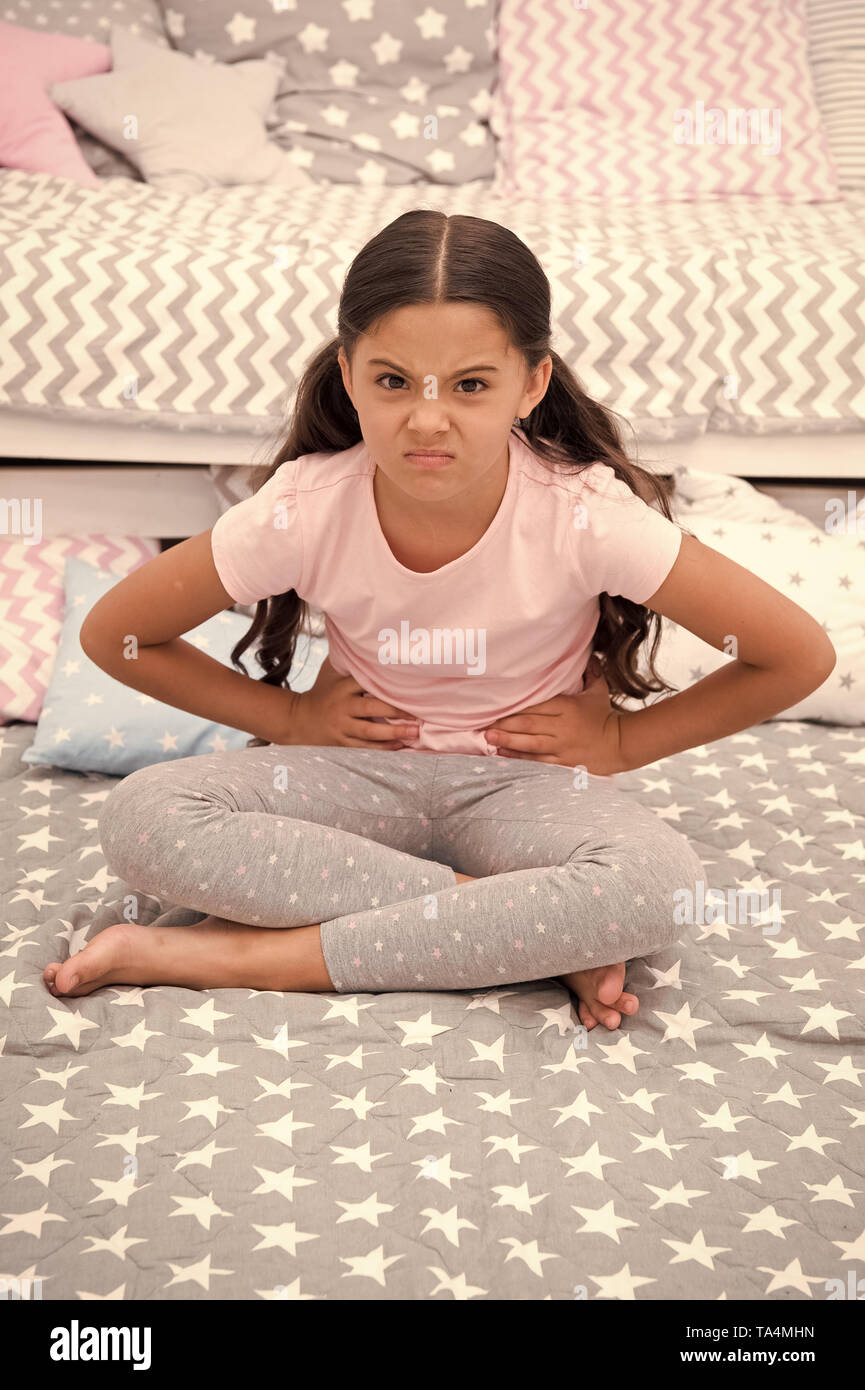 Capricious mood. Girl child sit in bedroom. Kid unhappy capricious ...