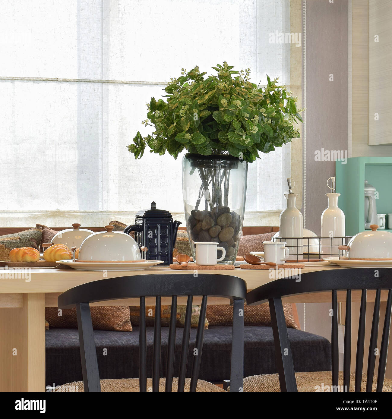 Breakfast setup on wooden table with nice vase and modern chair Stock ...
