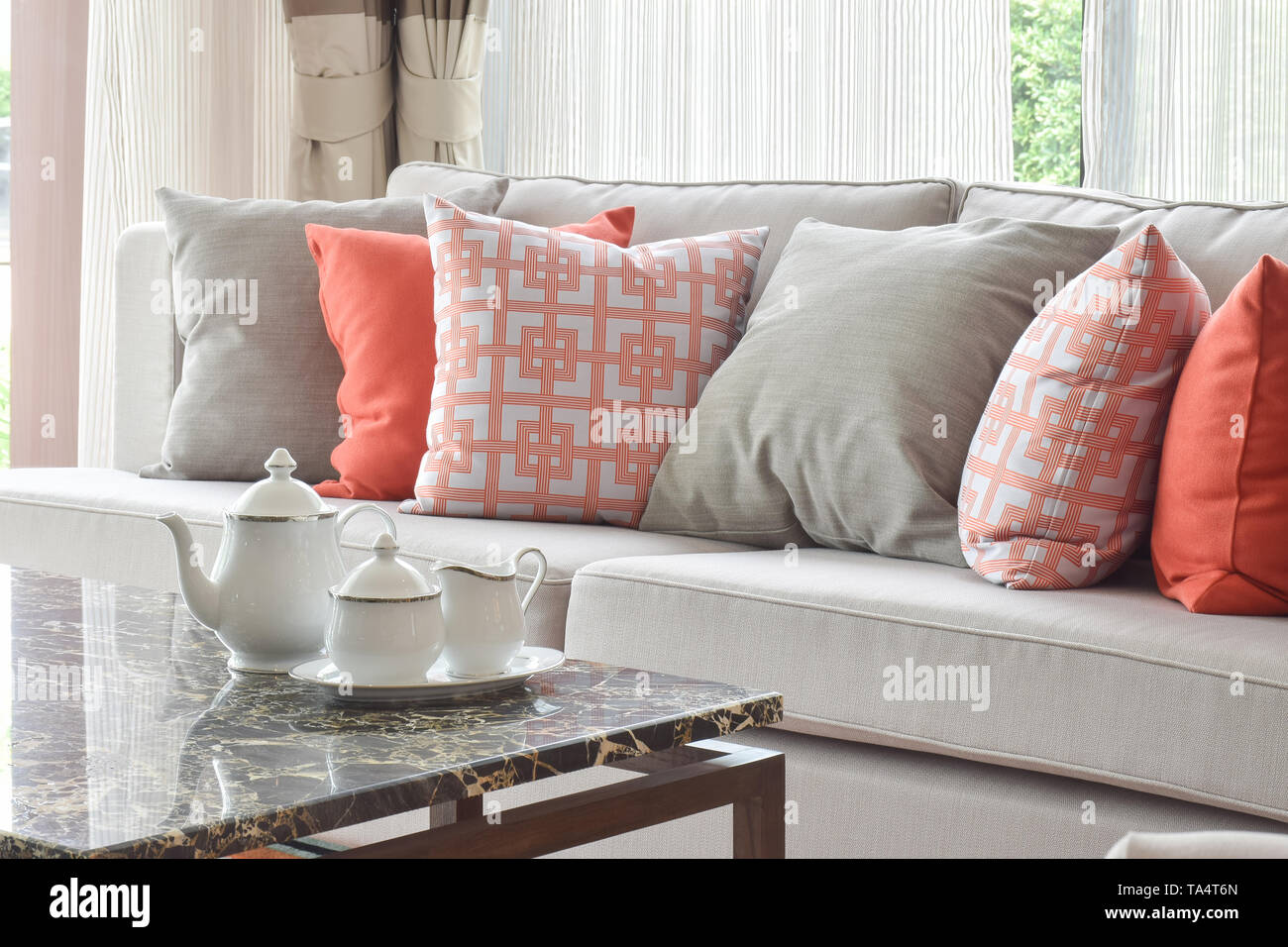 tea set on marble top table and lively sofa set Stock Photo - Alamy