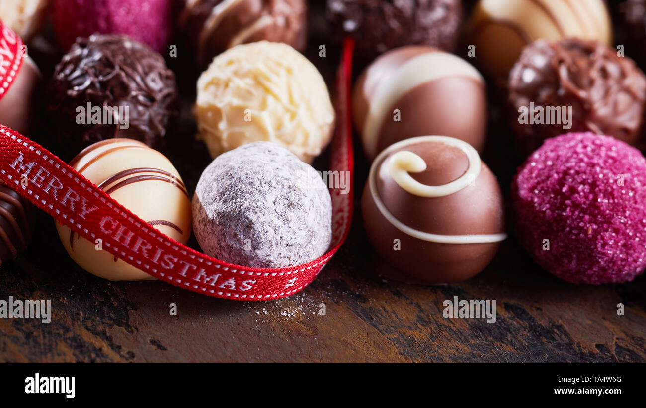 Merry Christmas festive chocolate background with a red ribbon with ...