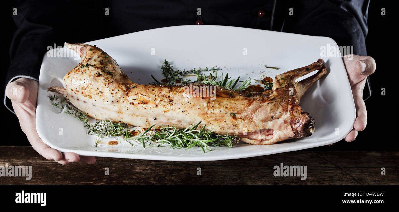 Cook holding a hare hi-res stock photography and images - Alamy
