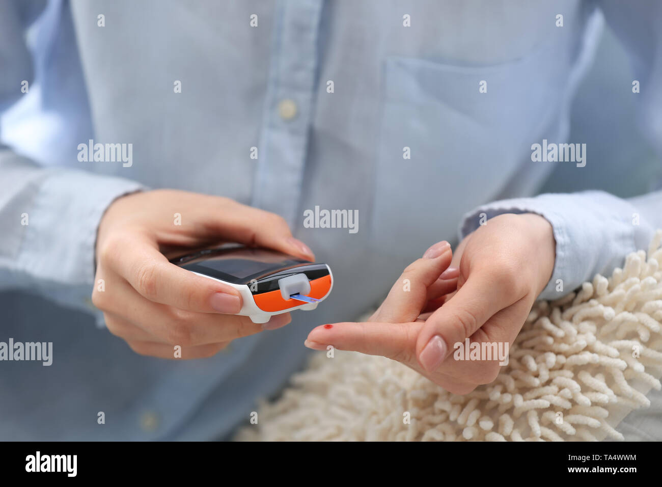 Woman taking diabetes test glucometer hi-res stock photography and ...