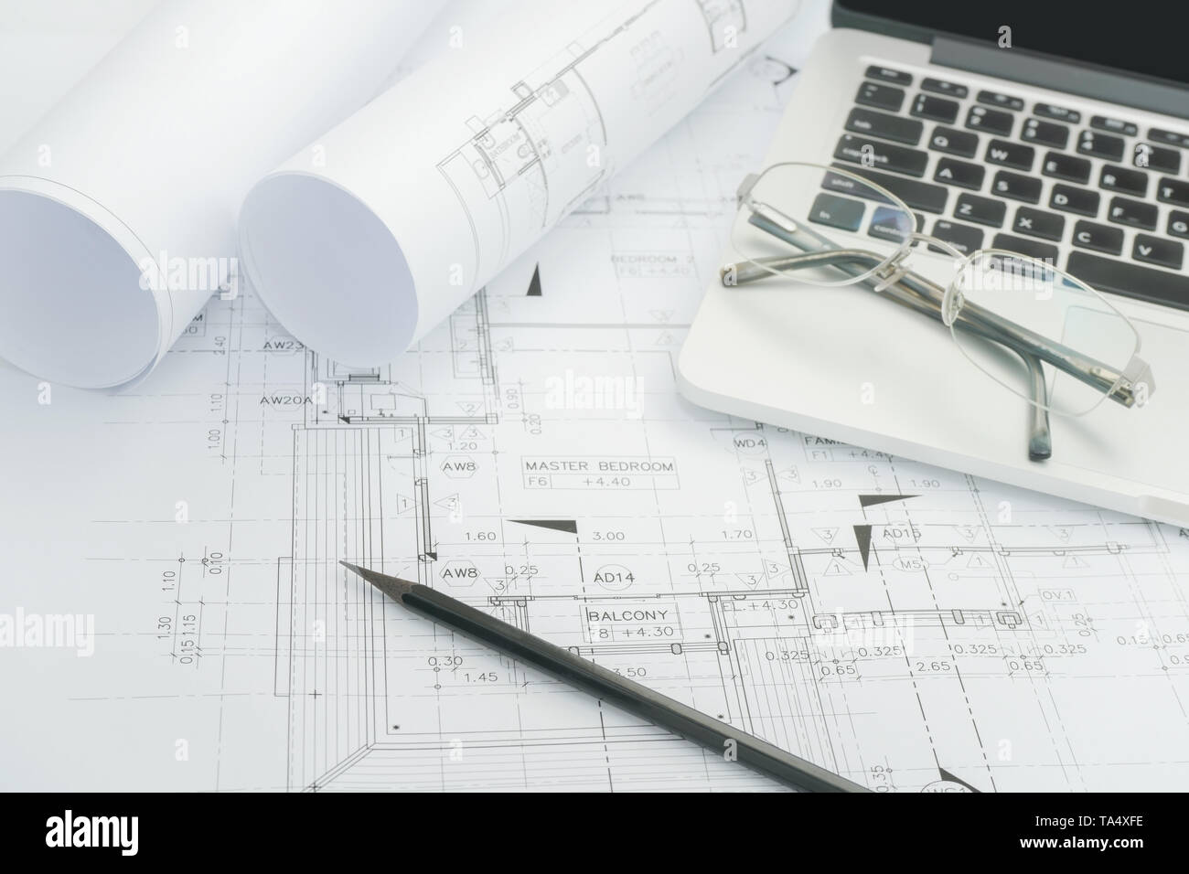 black pencil and computer laptop on architectural drawing paper for ...