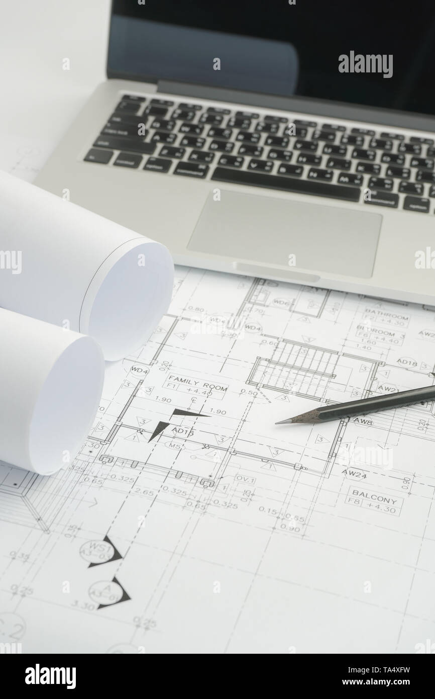 black pencil and computer laptop on architectural drawing paper for ...