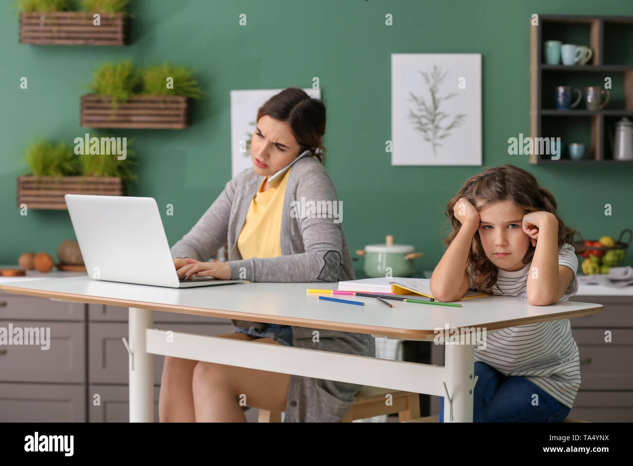 Mom multitasking in kitchen hi-res stock photography and images - Alamy