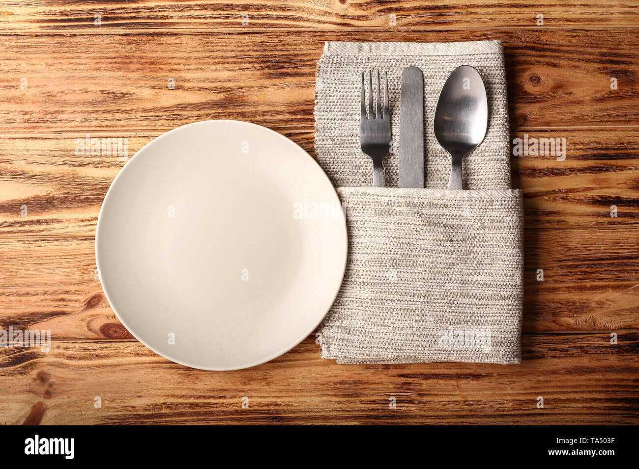 Simple table setting on wooden background Stock Photo - Alamy