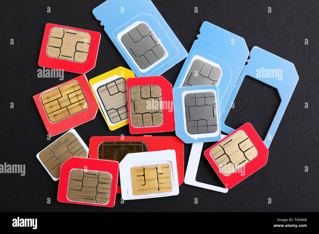 Many sim cards on dark background Stock Photo - Alamy