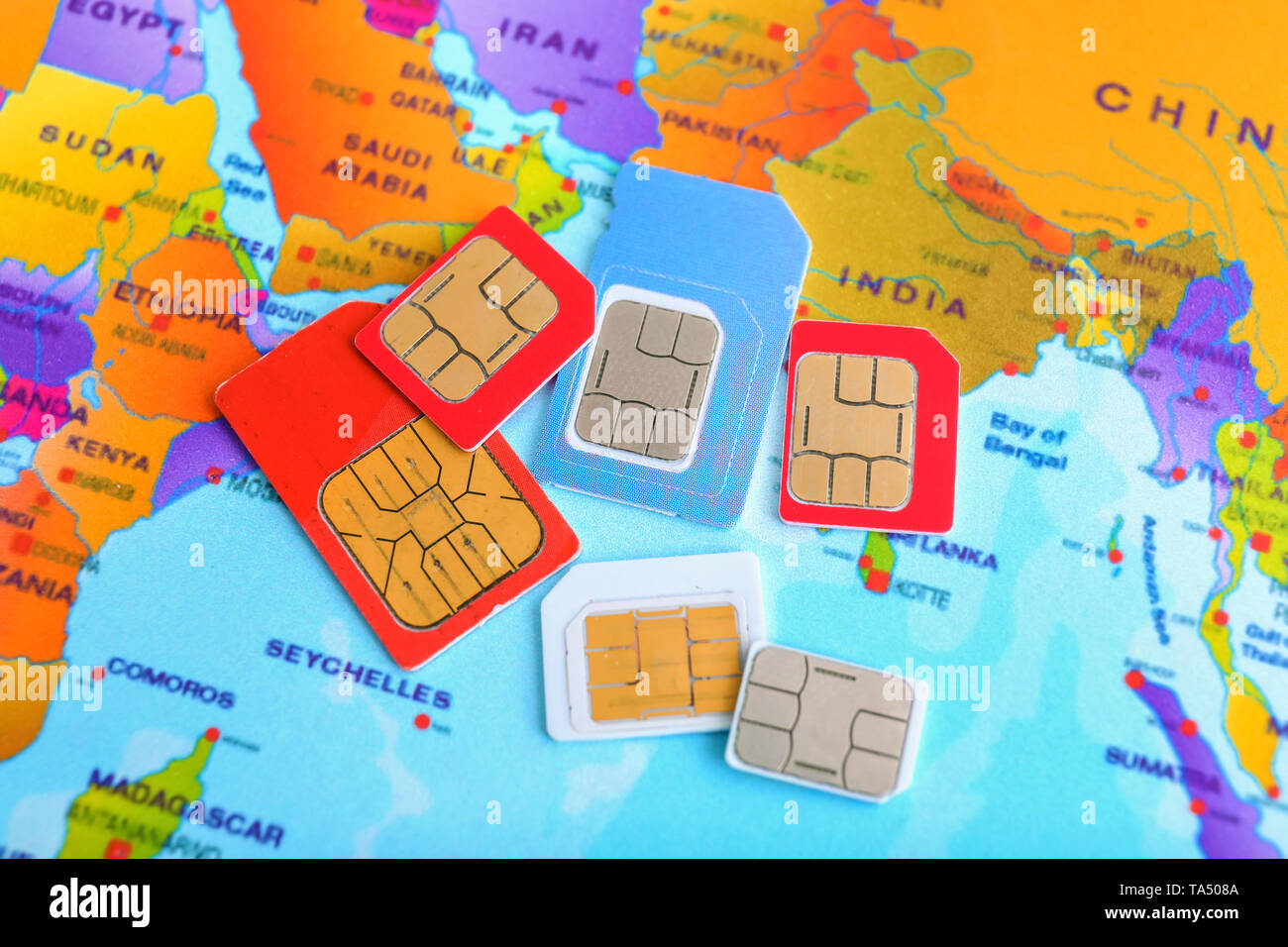 Many sim cards on world map Stock Photo - Alamy