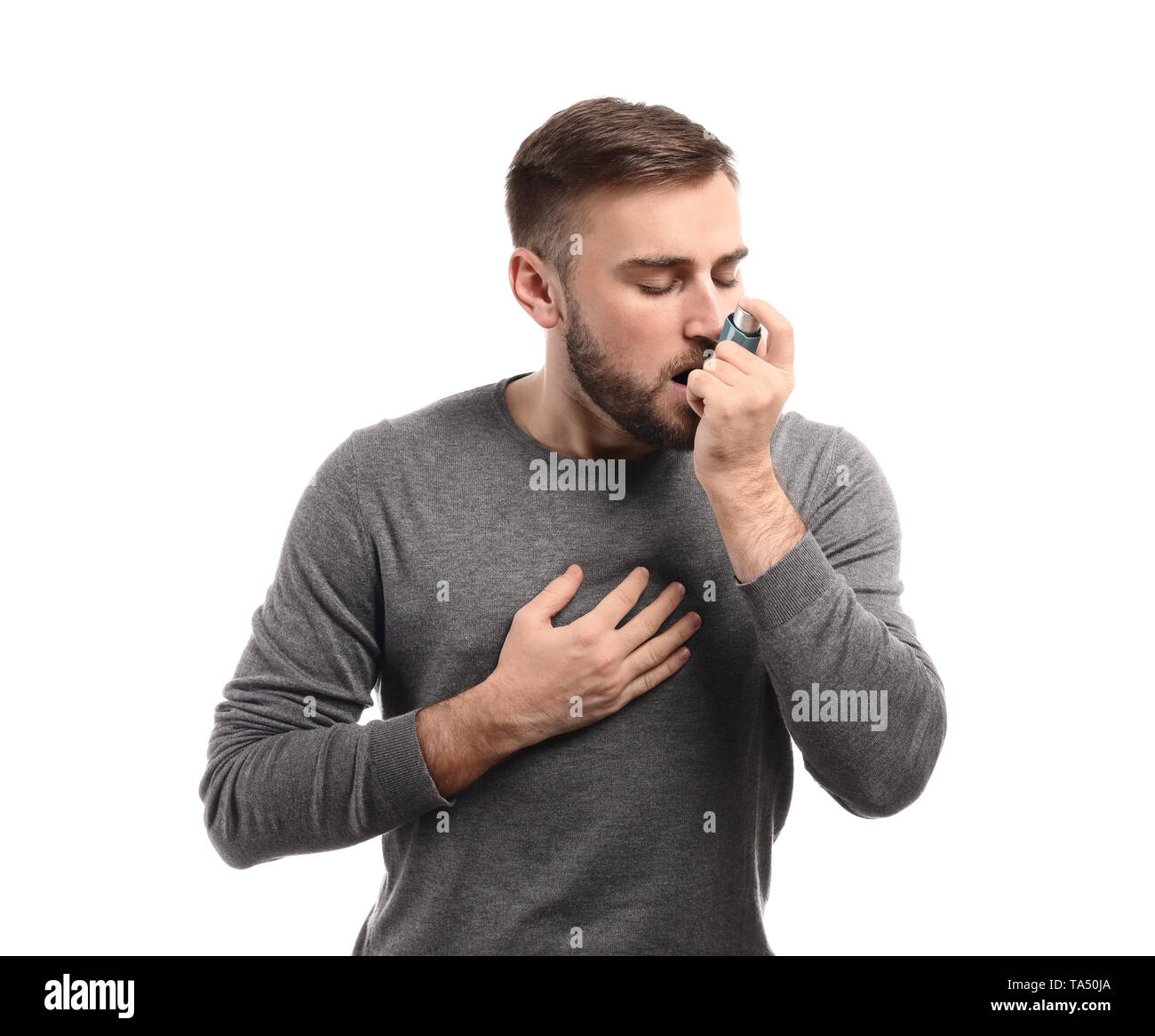 Young man with inhaler having asthma attack on white background Stock ...