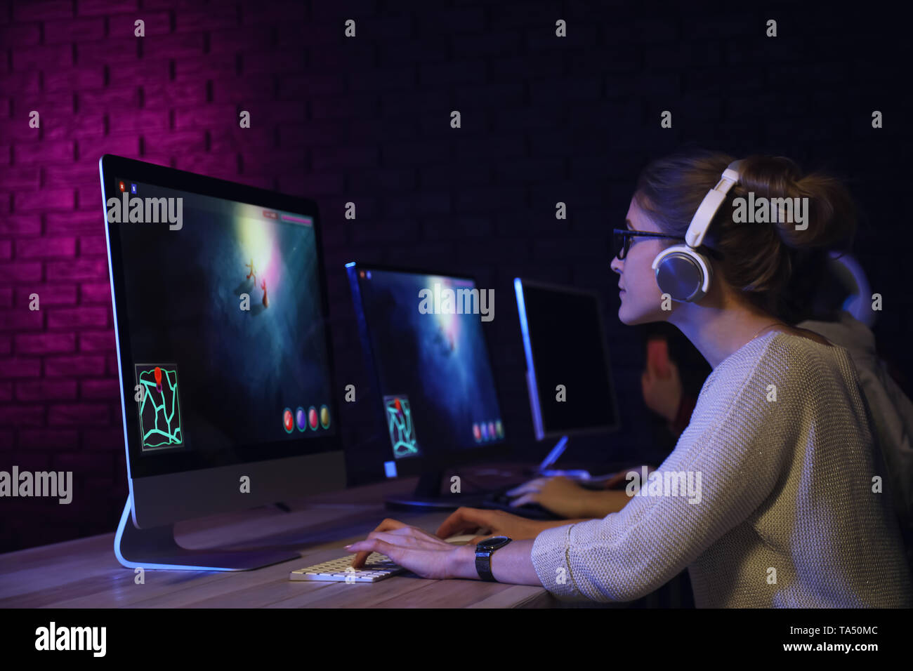 Young women playing computer game in club Stock Photo - Alamy