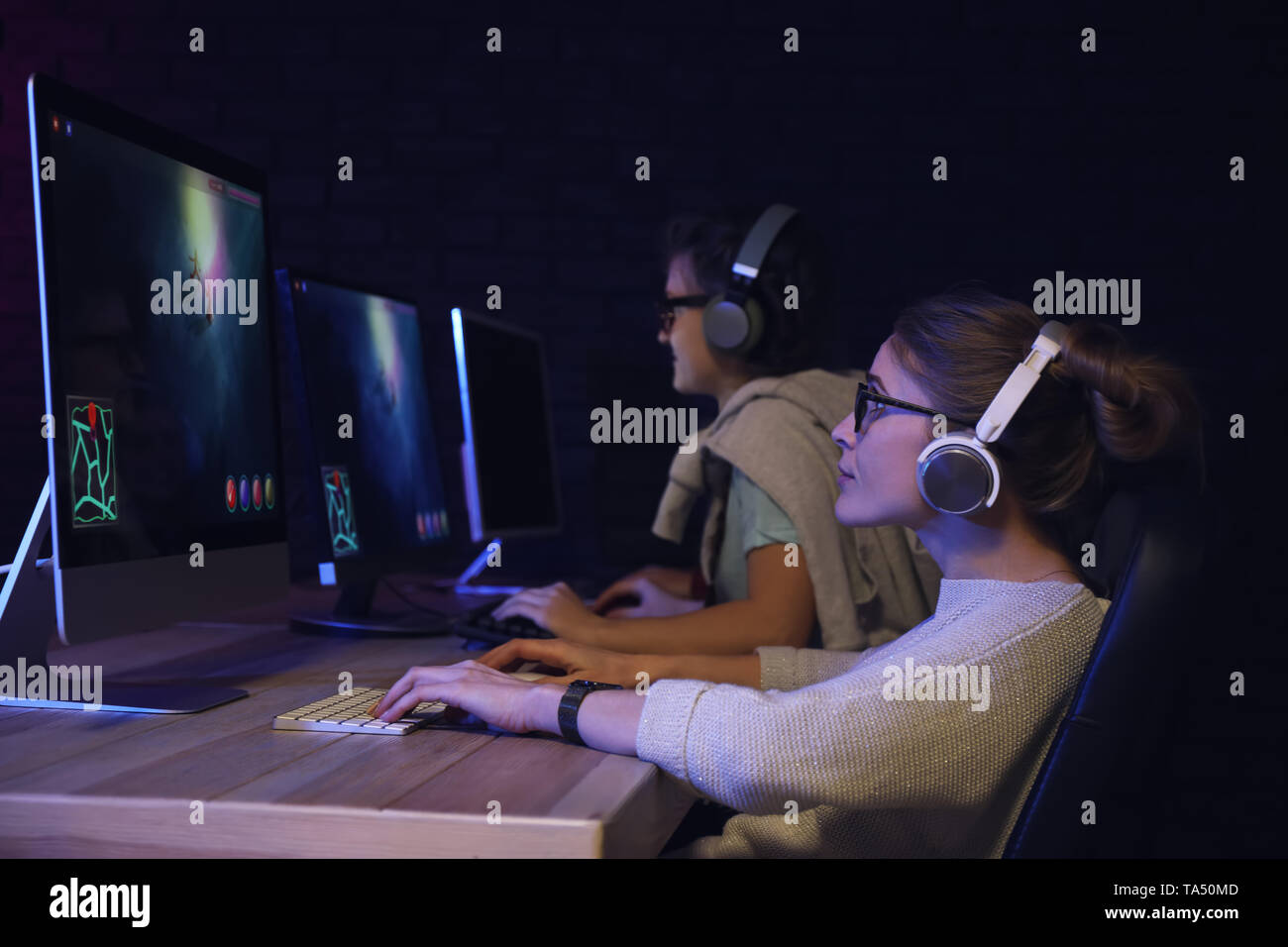 Young women playing computer game in club Stock Photo - Alamy