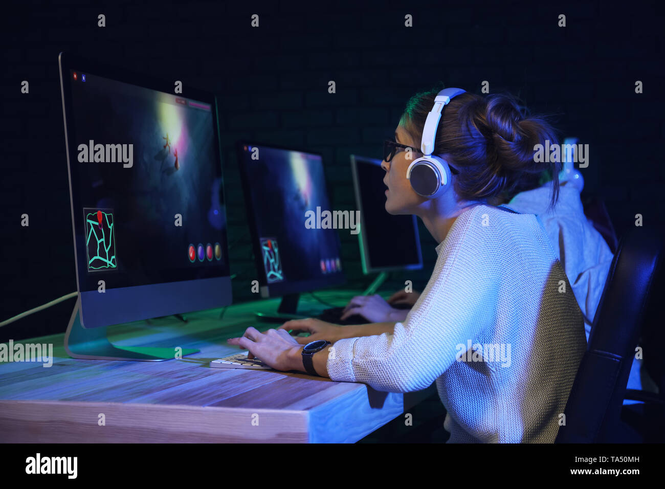 Young women playing computer game in club Stock Photo - Alamy