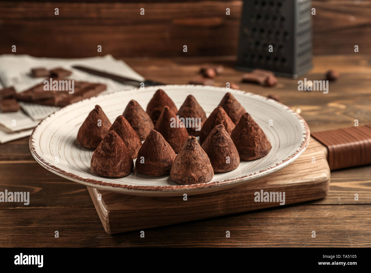 Plate with tasty sweet truffles on wooden table Stock Photo - Alamy