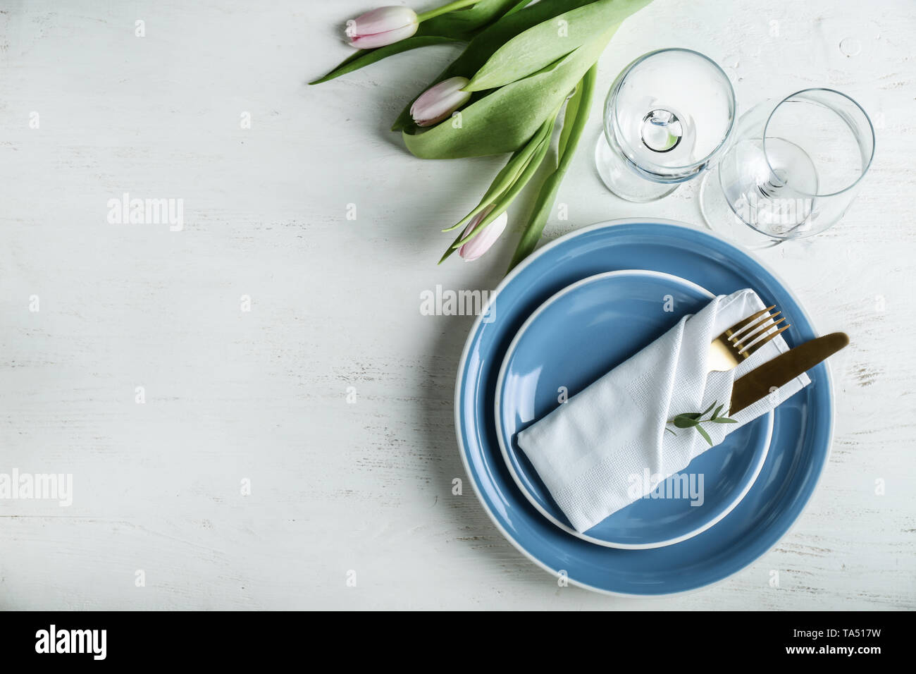 Simple table setting on white wooden background Stock Photo - Alamy
