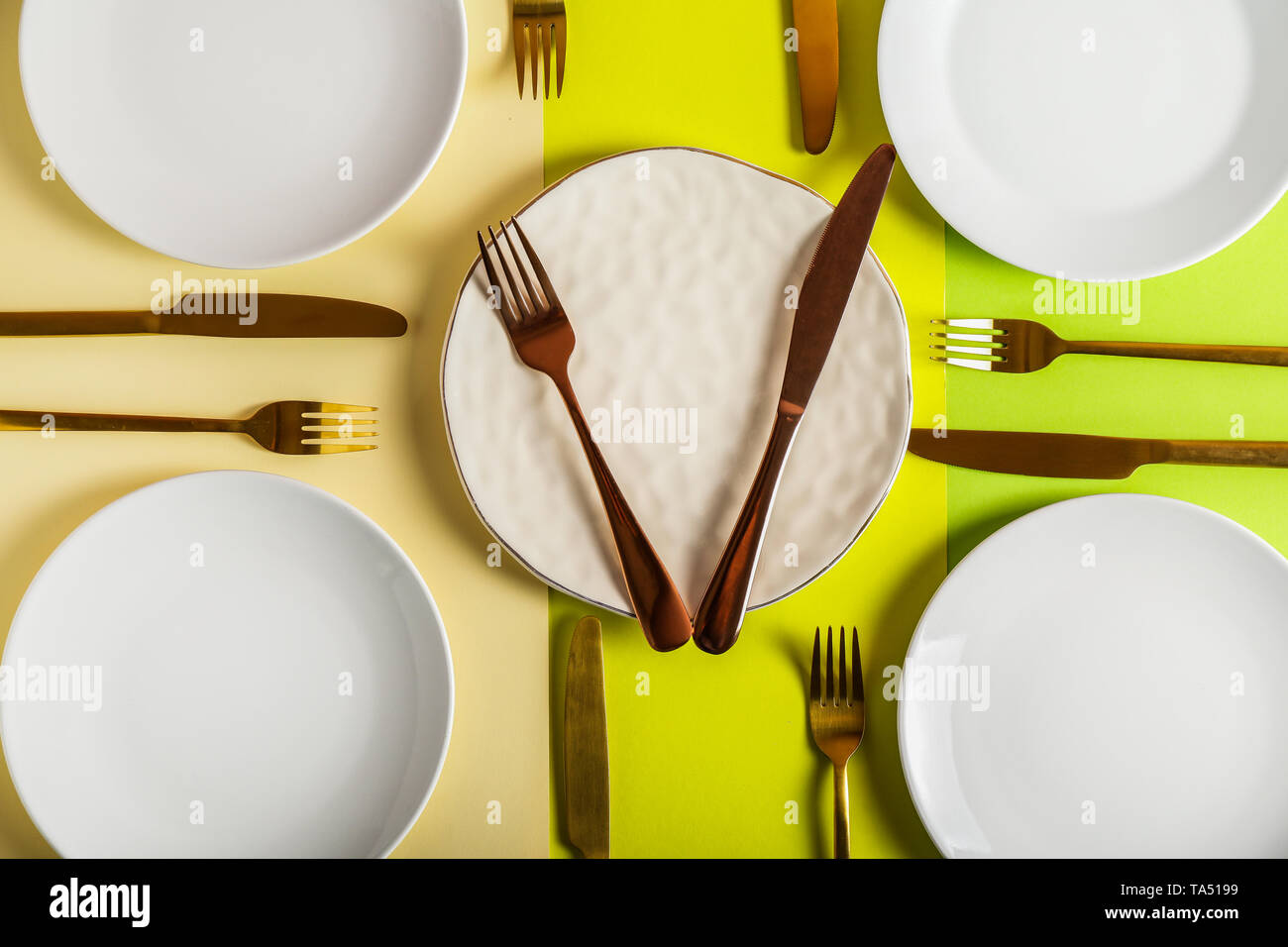 Simple table setting on color background Stock Photo - Alamy