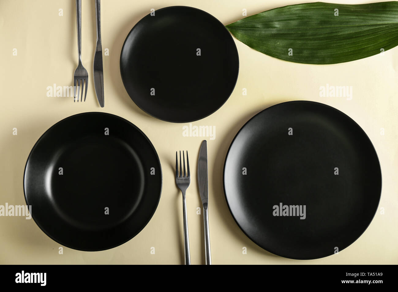 Simple table setting on light background Stock Photo - Alamy