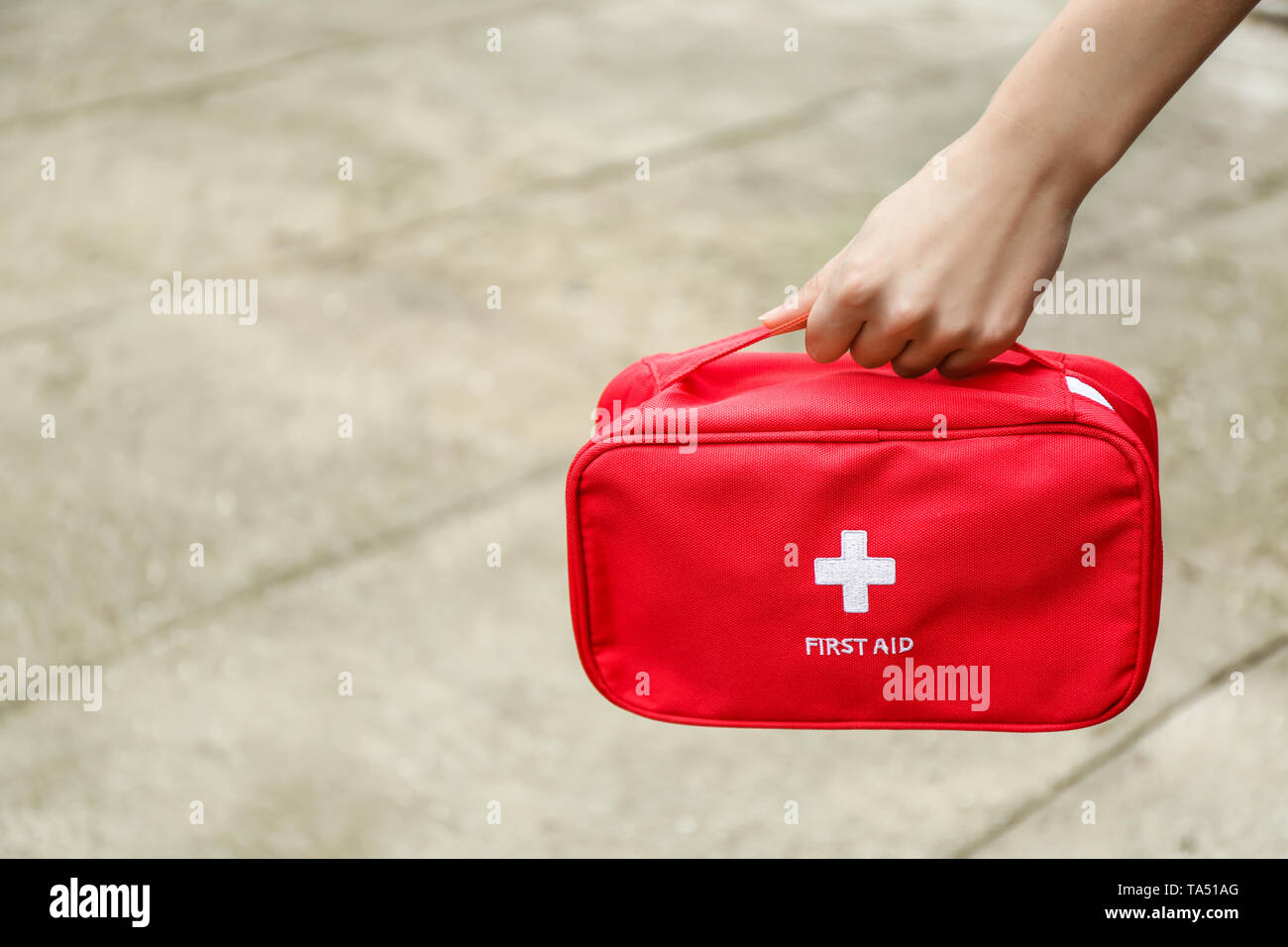Woman with first aid kit outdoors Stock Photo - Alamy