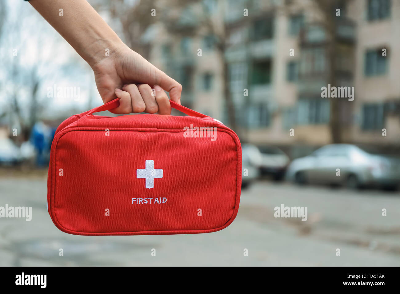 Woman with first aid kit outdoors Stock Photo - Alamy
