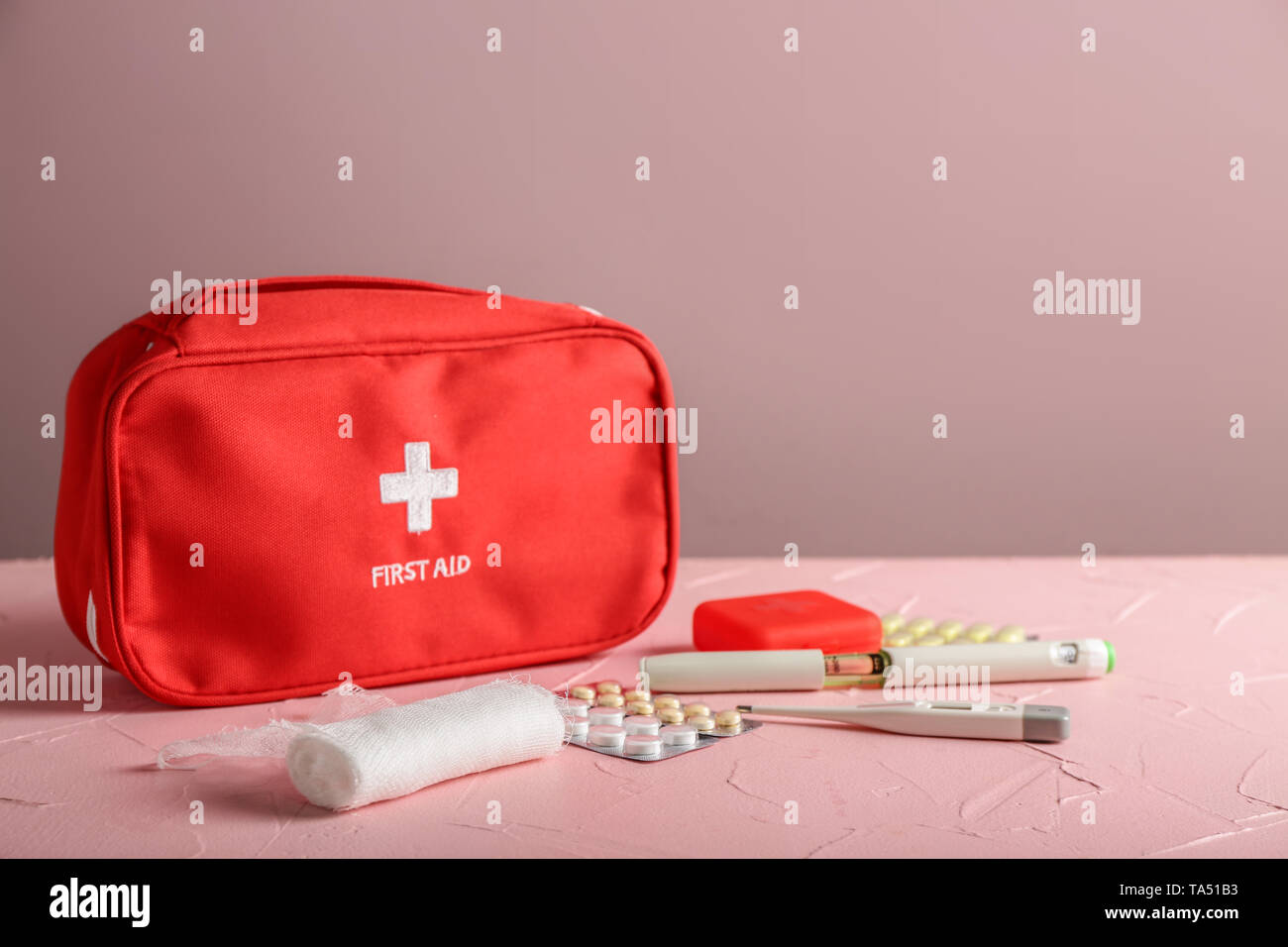 First aid kit on color table Stock Photo - Alamy