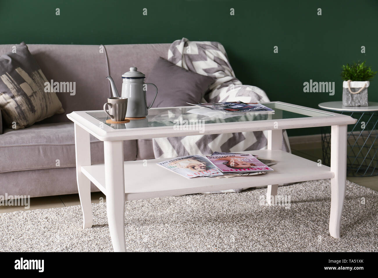 Interior of beautiful modern room with table and sofa Stock Photo - Alamy