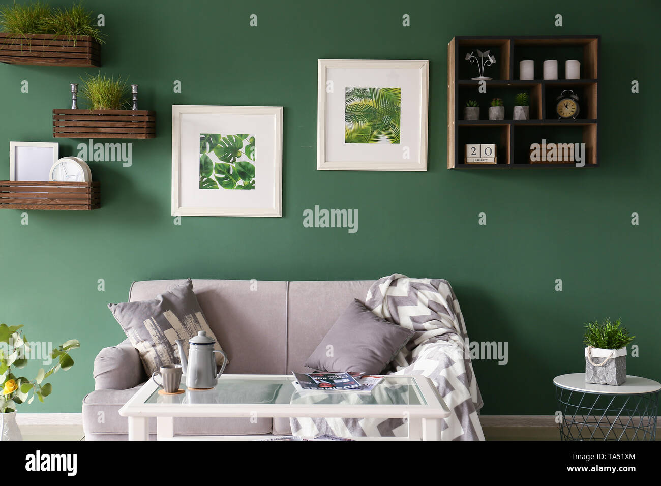 Interior of beautiful modern room with green wall Stock Photo - Alamy