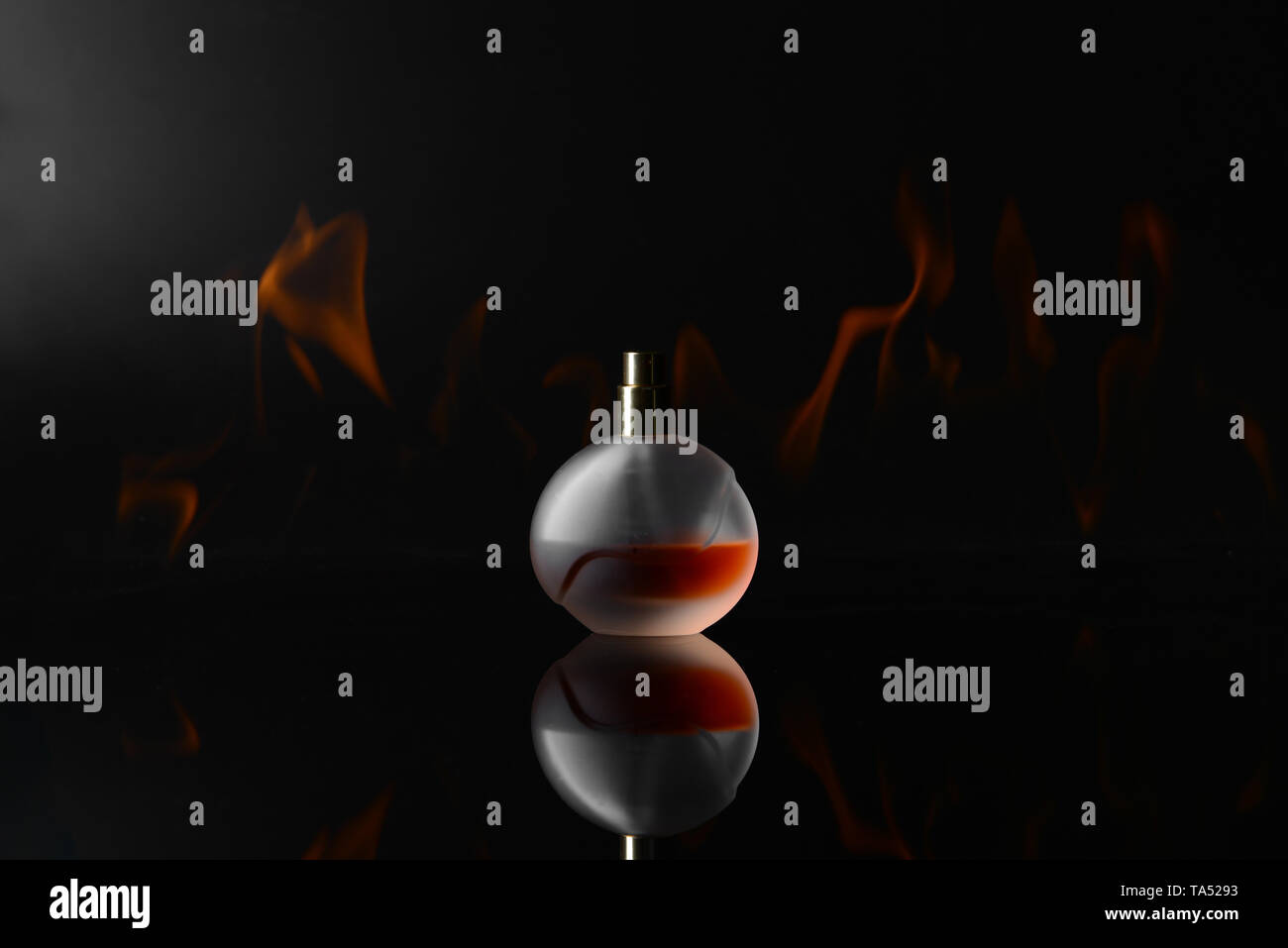Bottle of perfume and burning flame on dark background Stock Photo - Alamy