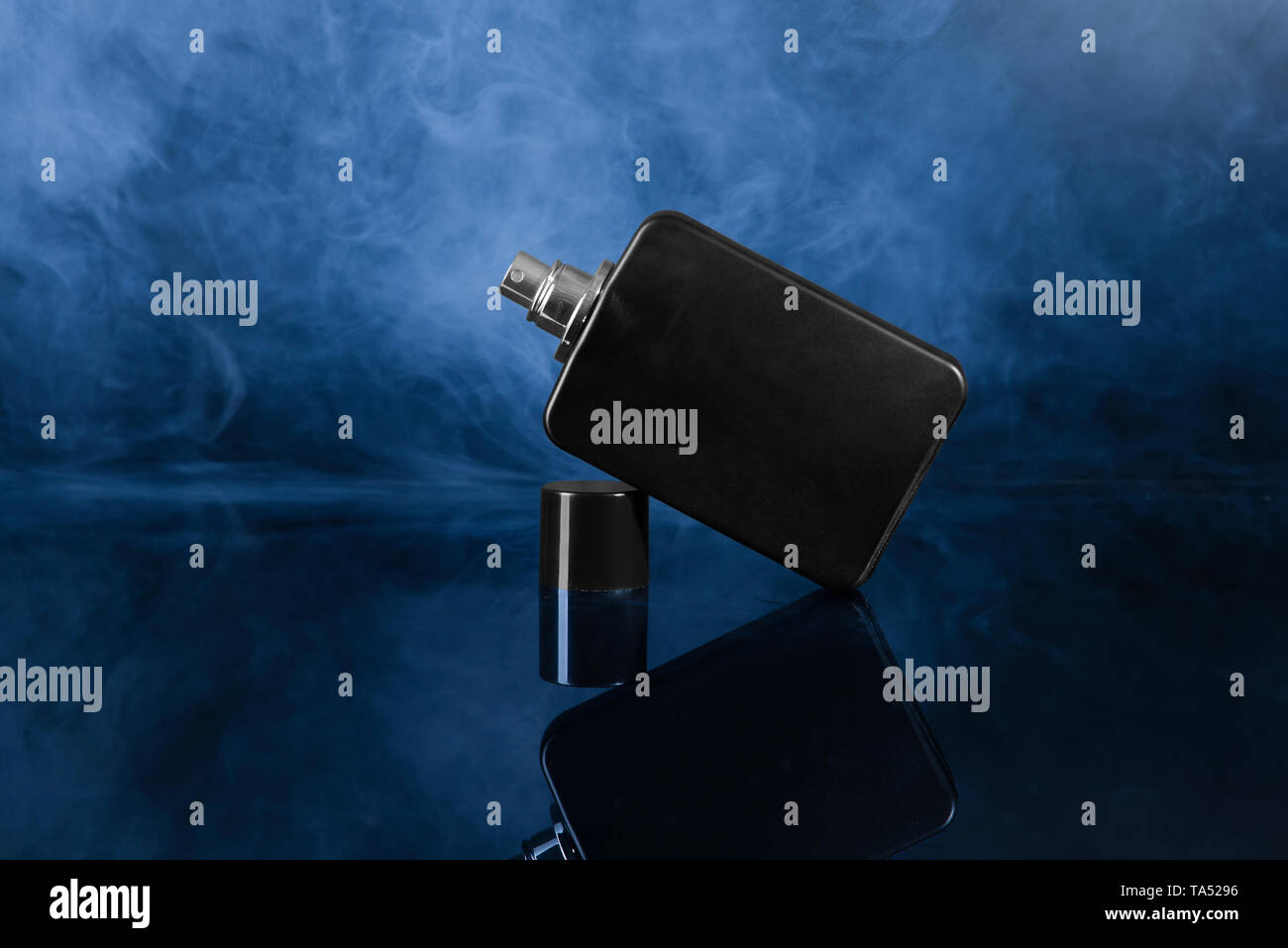 Bottle of perfume in smoke on dark background Stock Photo - Alamy