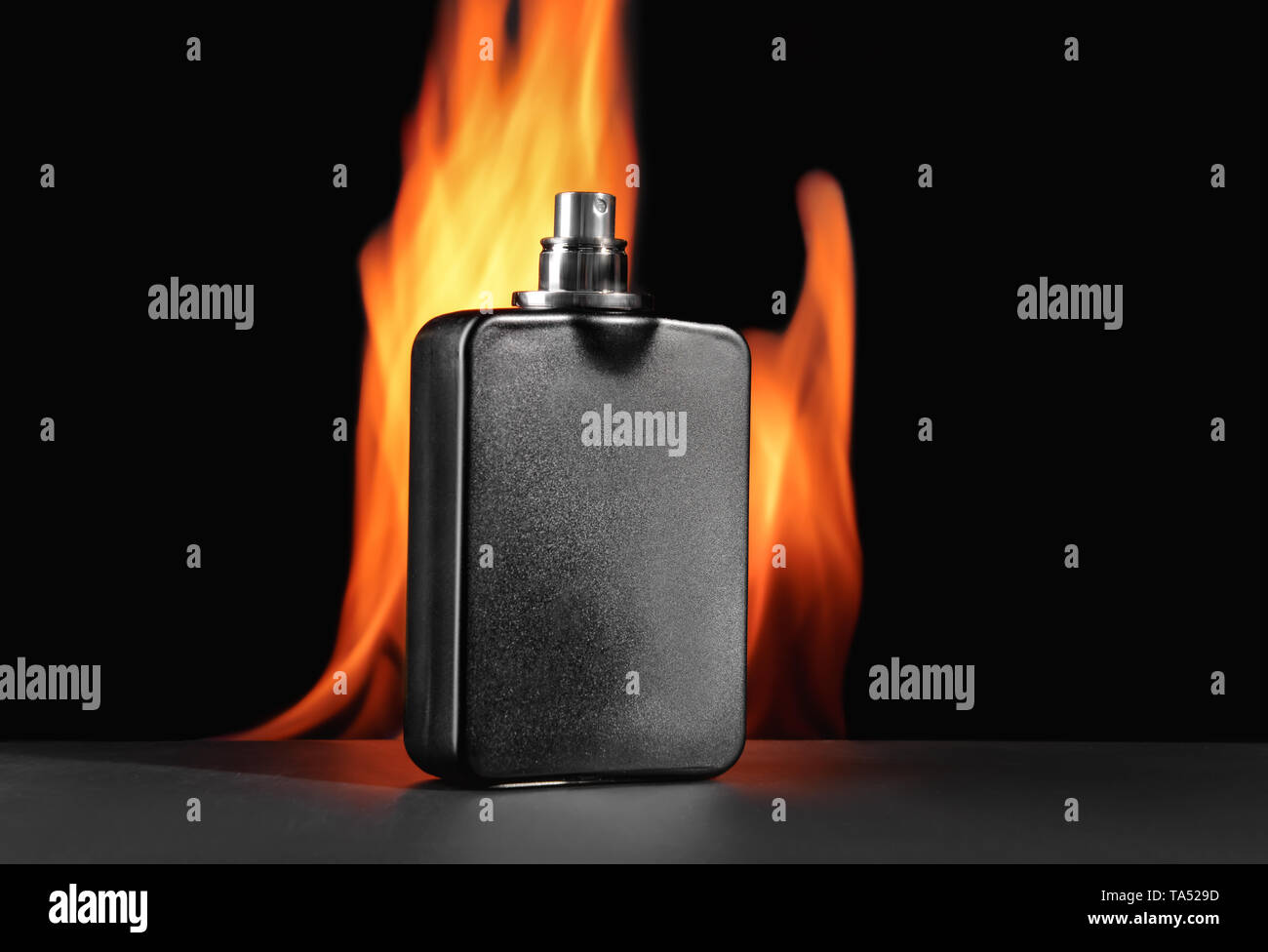 Bottle of perfume and burning flame on dark background Stock Photo - Alamy