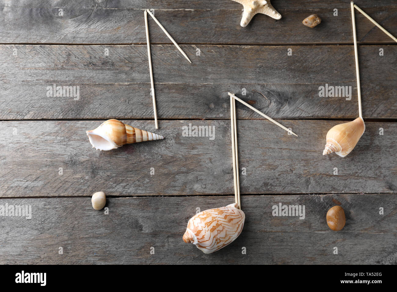 Music notes made of sea shells on wooden background Stock Photo - Alamy