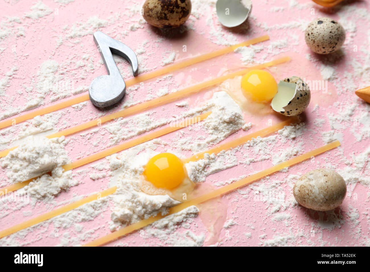 Composition with music note, flour and quail eggs on color background ...