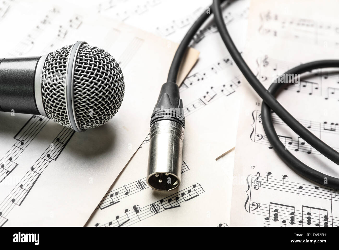 Microphone and music sheets on table Stock Photo - Alamy