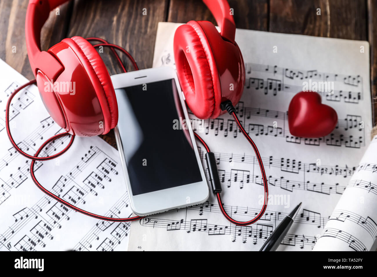 Mobile phone, headphones and music sheets on table Stock Photo - Alamy