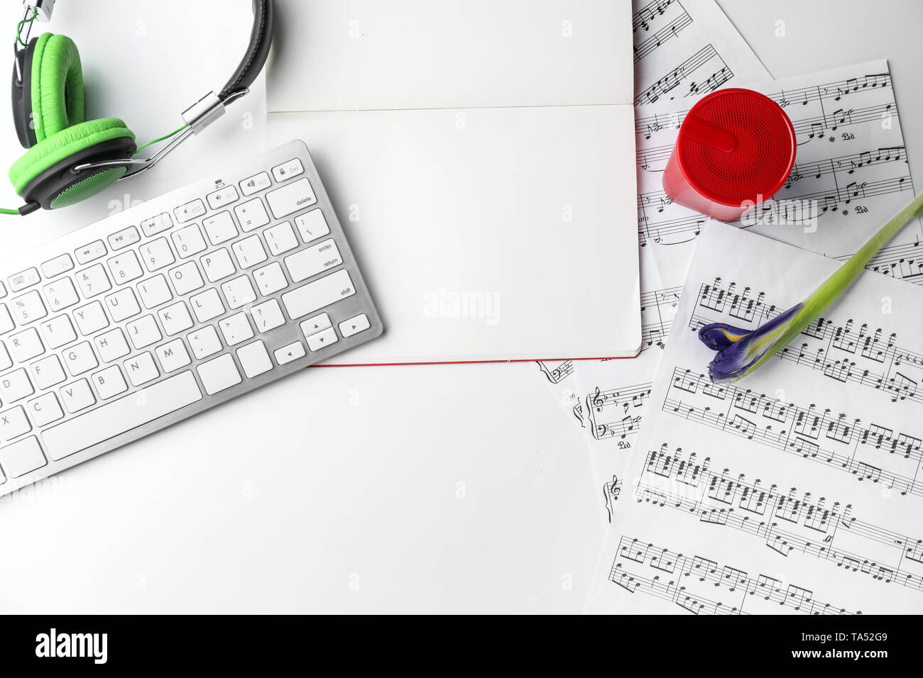 Computer keyboard, notebook and music sheets on table Stock Photo - Alamy