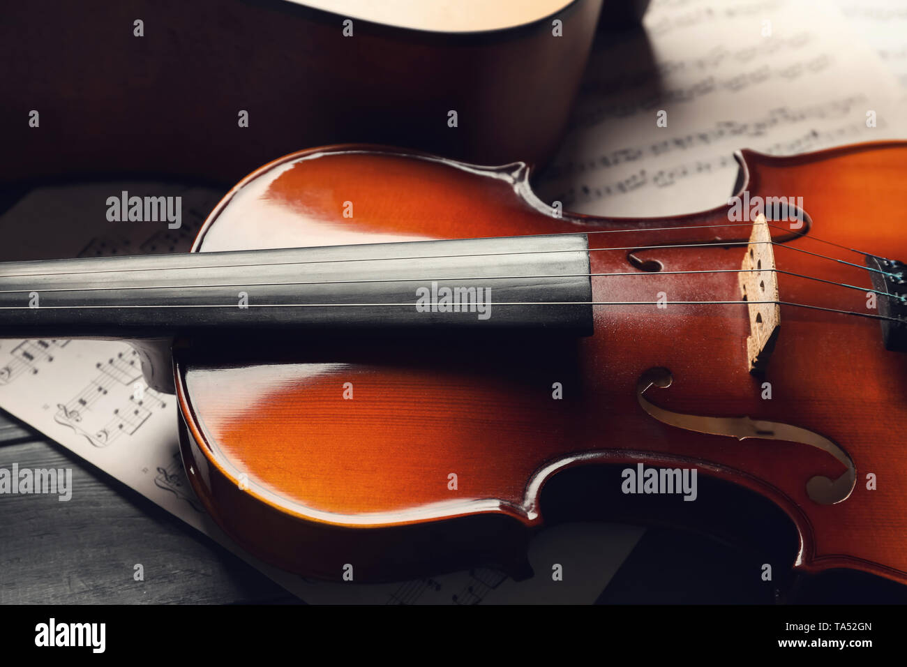 Violin and music sheets on table, closeup Stock Photo - Alamy
