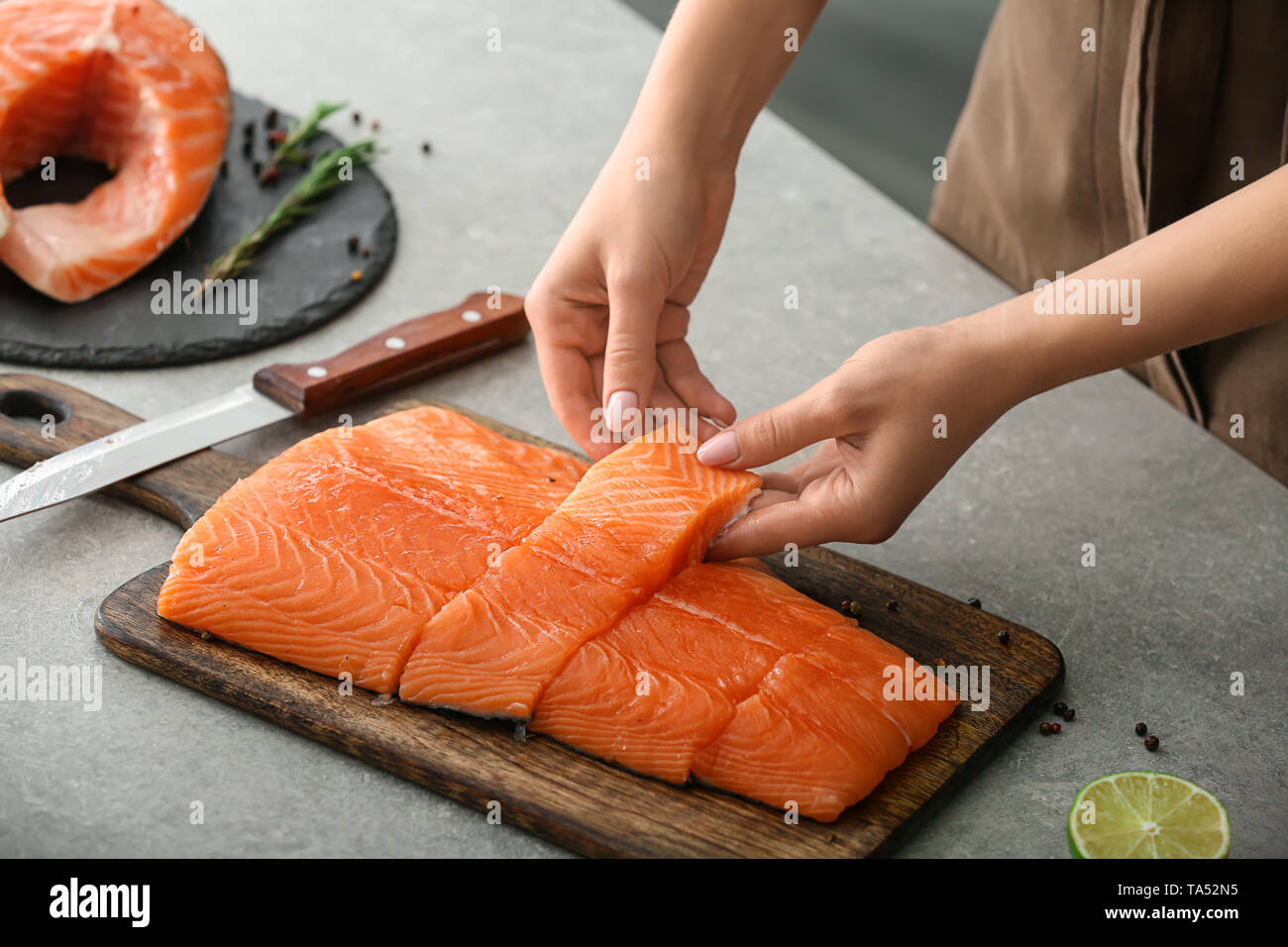 Woman cut salmon steak hi-res stock photography and images - Alamy