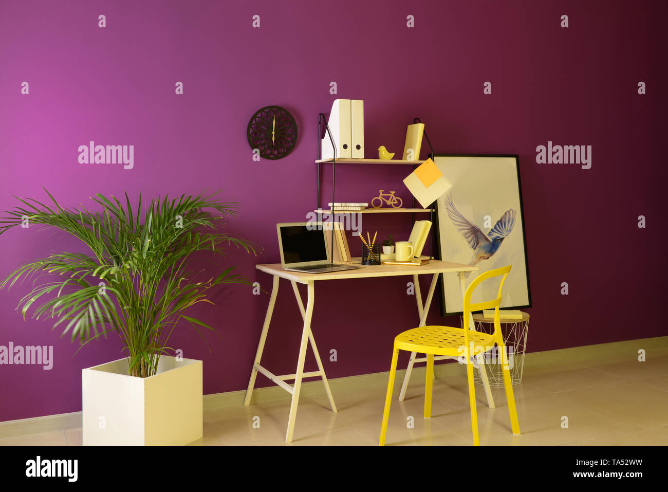 Stylish workplace with modern laptop near color wall Stock Photo - Alamy