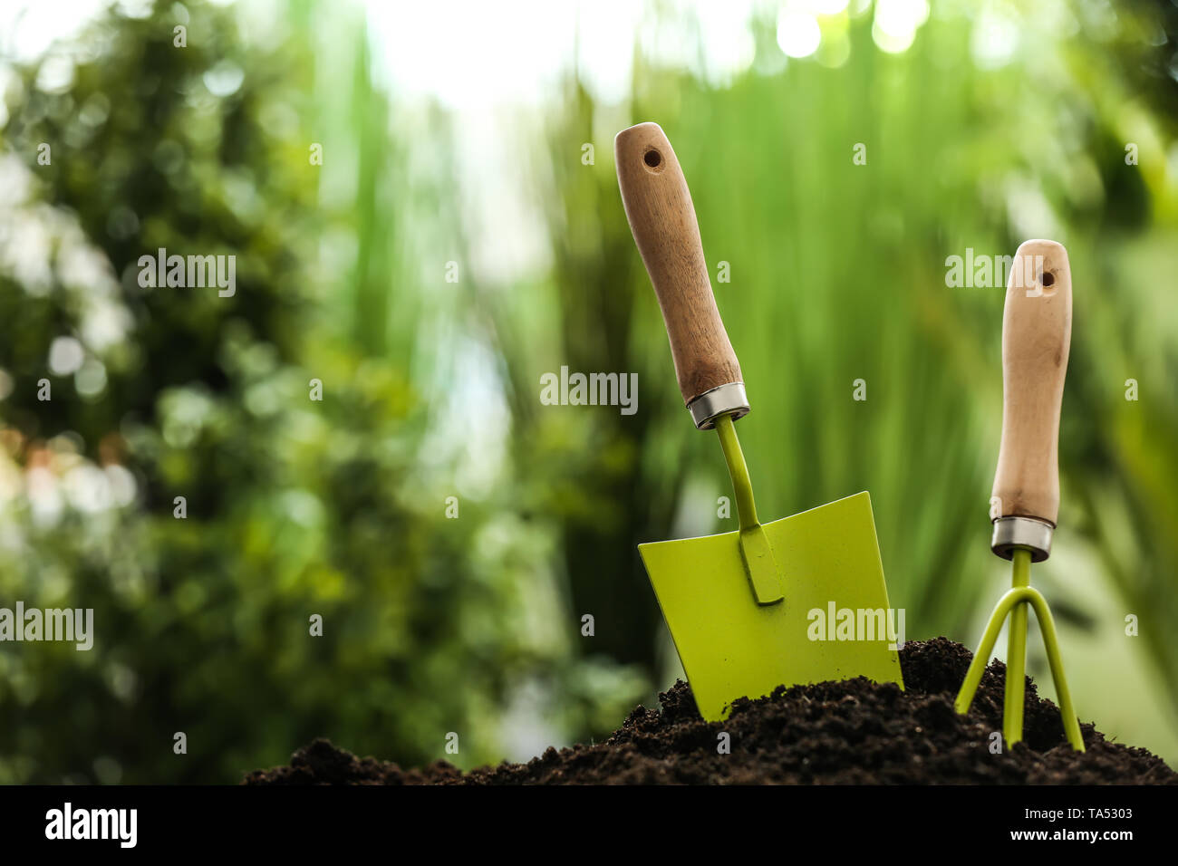 Gardening tools with heap of soil outdoors Stock Photo - Alamy