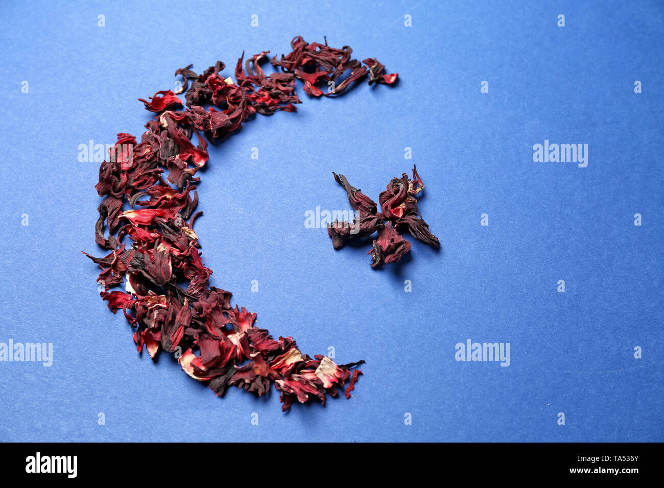 Half-moon and star made of karkade flowers as symbol of Islam on color ...