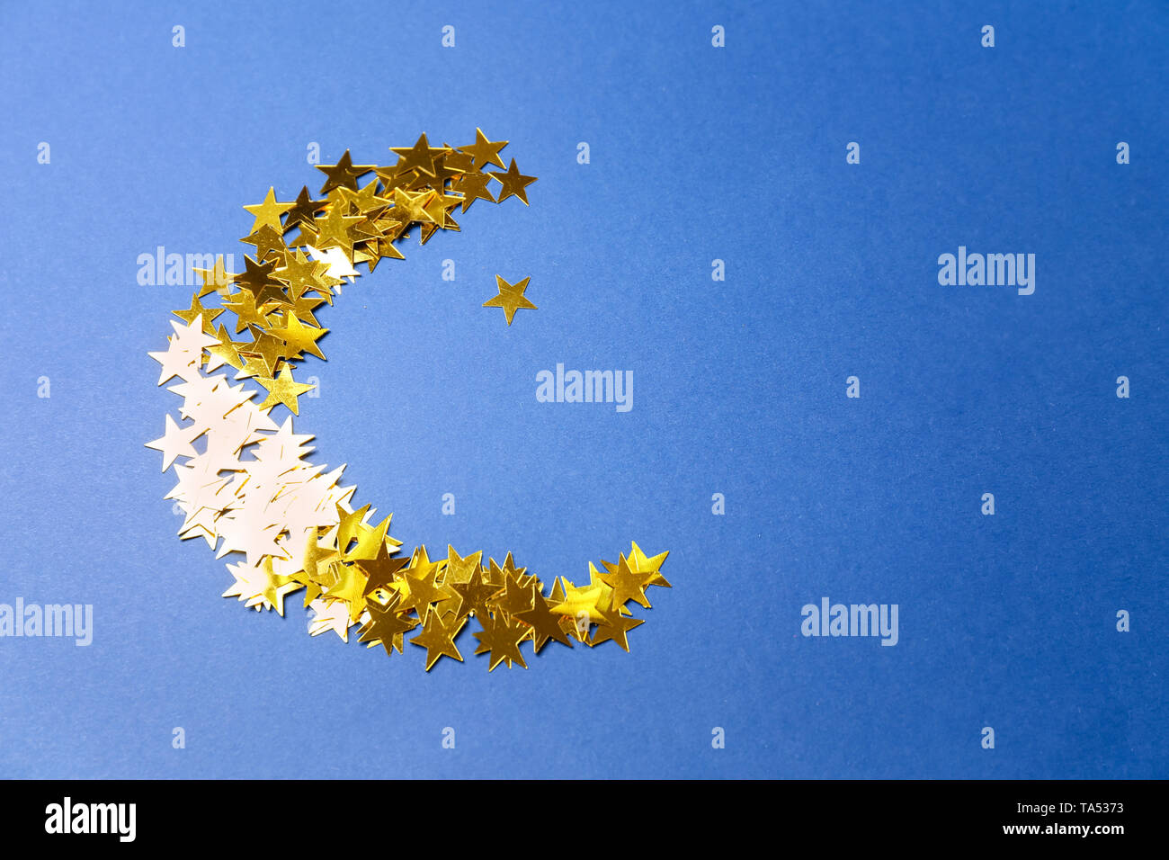 Half-moon made of golden stars as symbol of Islam on color background ...