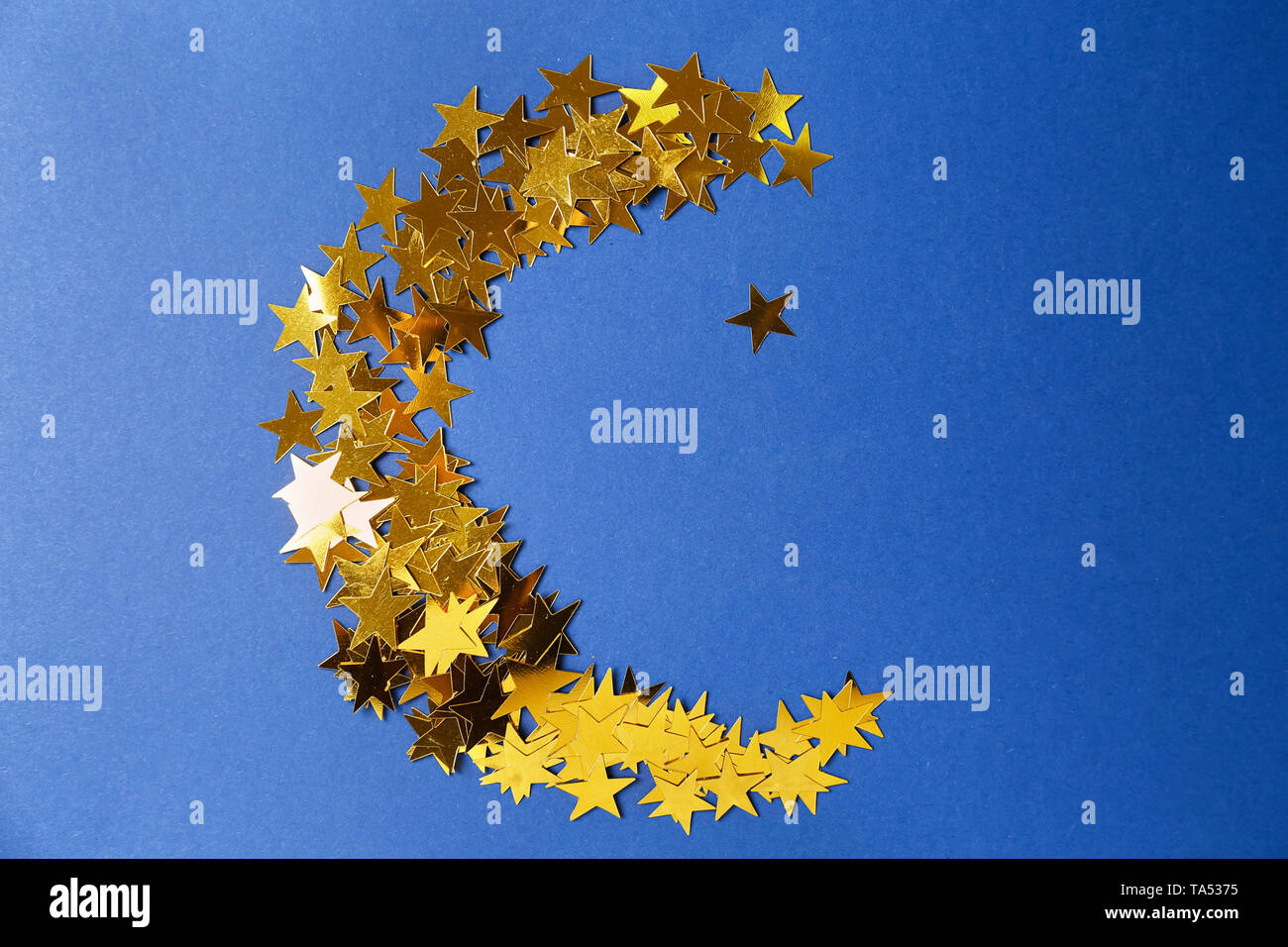 Half-moon made of golden stars as symbol of Islam on color background ...