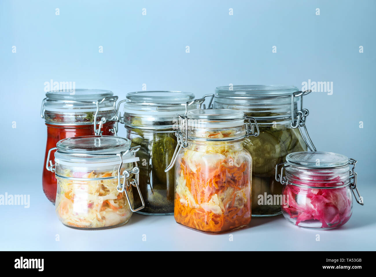 Glass jars with fermented vegetables on white background Stock Photo ...