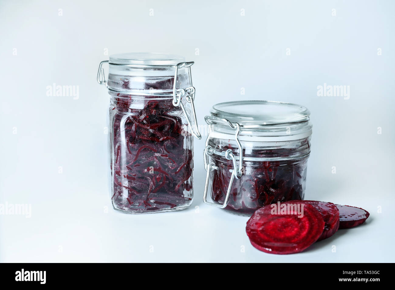 Glass jars with fermented beetroot on white background Stock Photo - Alamy